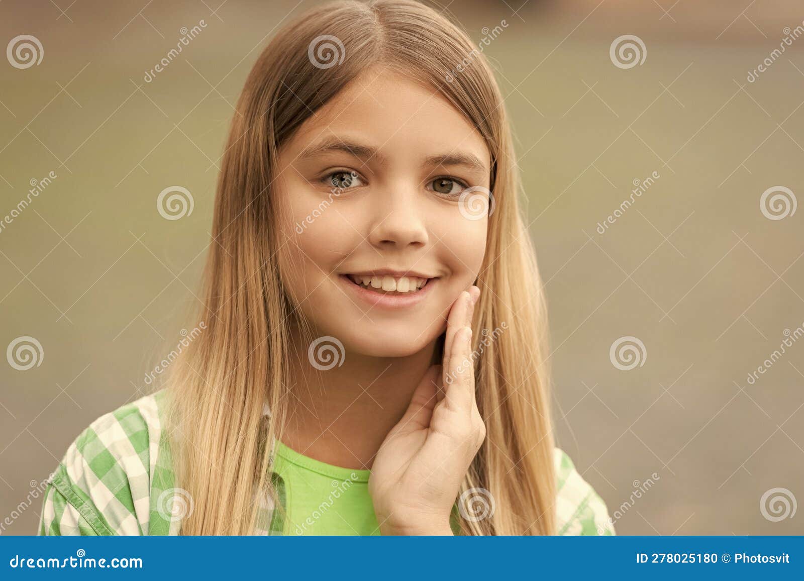 Portrait Of Happy Teenager Girl With Smiling Face Holding Hand On Cheek