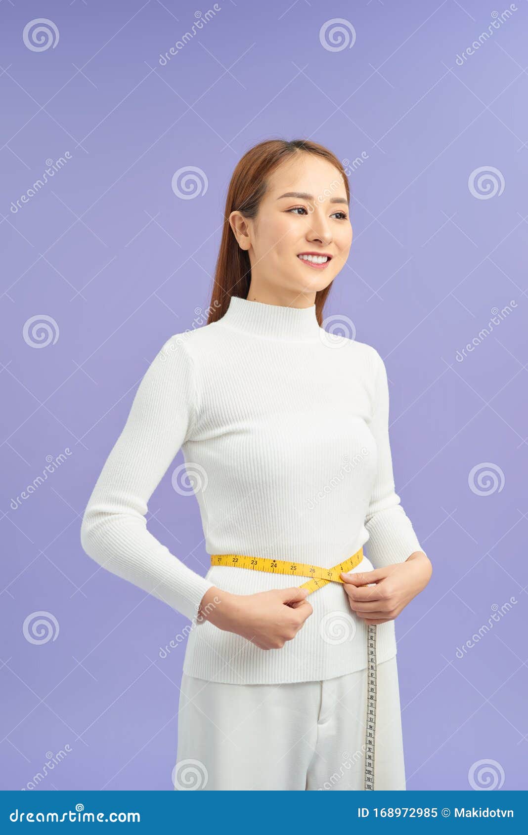 Portrait of a Happy Young Asian Woman Holding Measuring Tape Around Her ... Portrait of a Happy Young Asian Woman Holding Measuring Tape Around Her ...