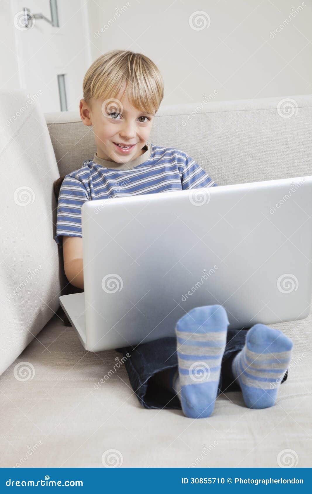 Portrait of Happy Young Boy Using Laptop on Sofa Stock Photo - Image of ...