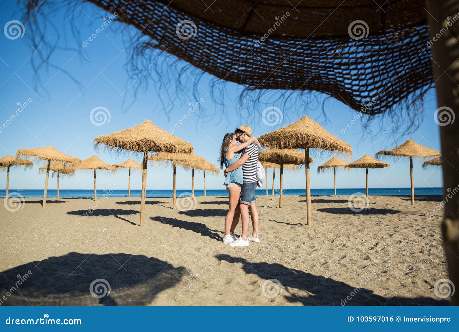 Happy Young Couple Cuddling on Beach Stock Photo - Image of full ...