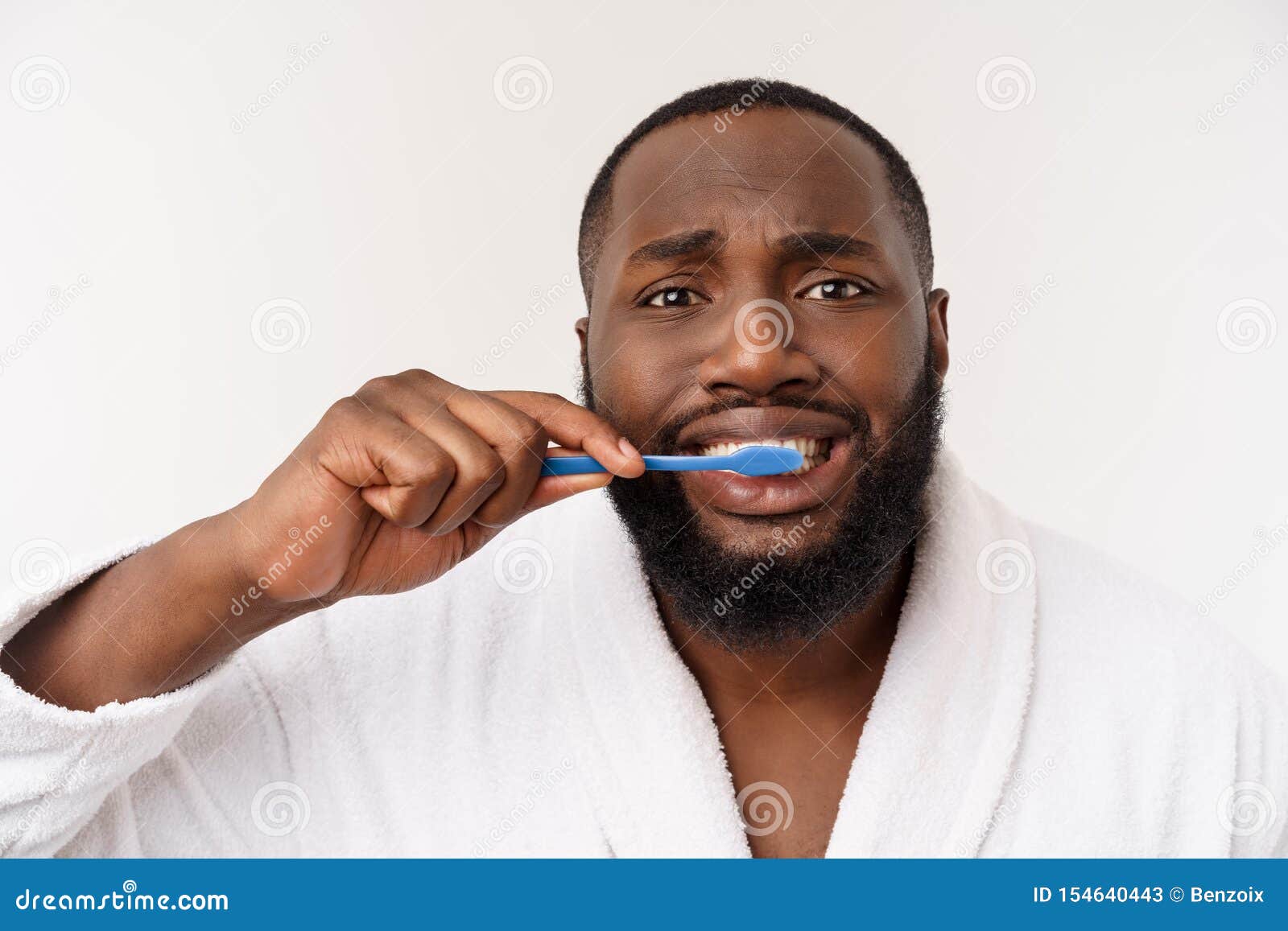 Portrait of a Happy Young Dark-anm Brushing His Teeth with Black ...