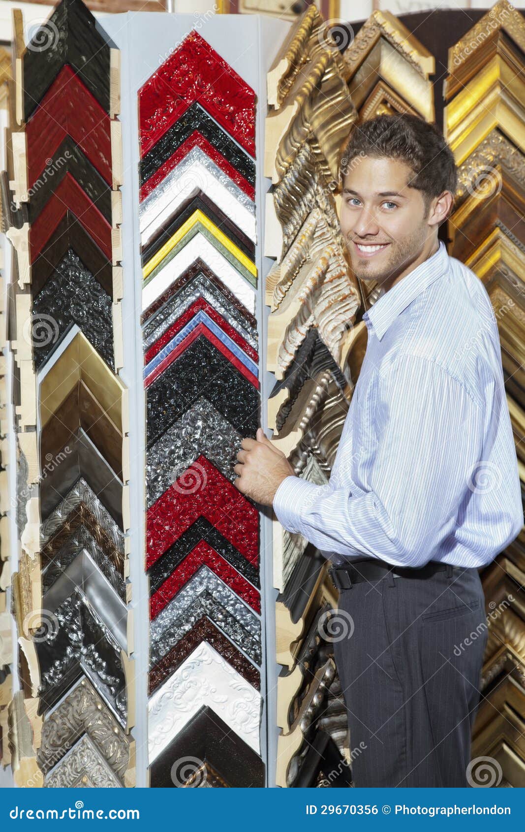 Portrait of a Happy Young Man Browsing at a Frame Store Stock Photo ...