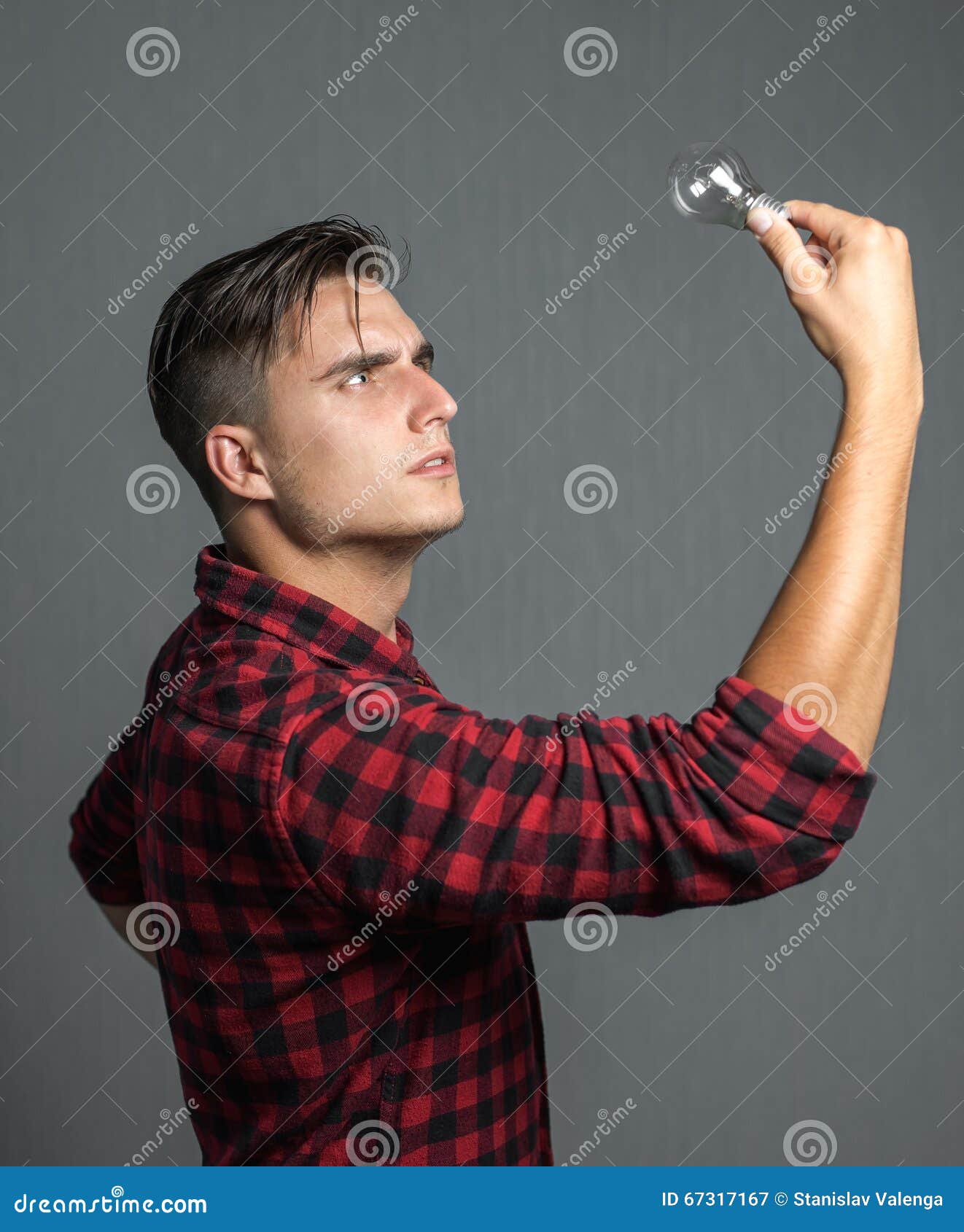 Portrait of a Happy Young Man Holding Light Bulb Stock Image - Image of ...