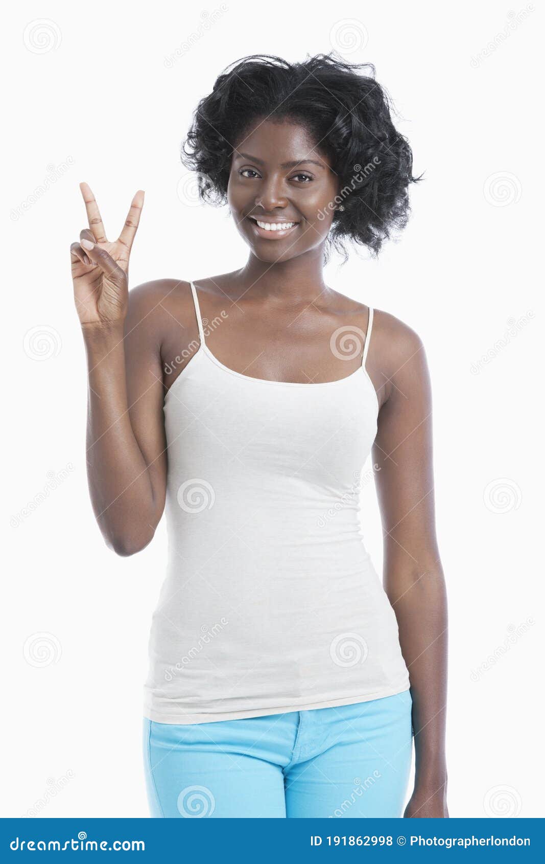 Portrait of Happy Young Woman Gesturing Peace Sign Over White ... Portrait of Happy Young Woman Gesturing Peace Sign Over White ...