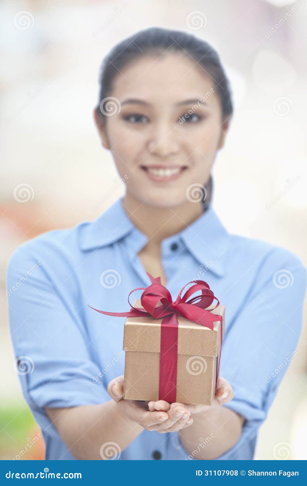 Portrait of Happy Young Woman Presenting a Gift Box Stock Photo - Image ...