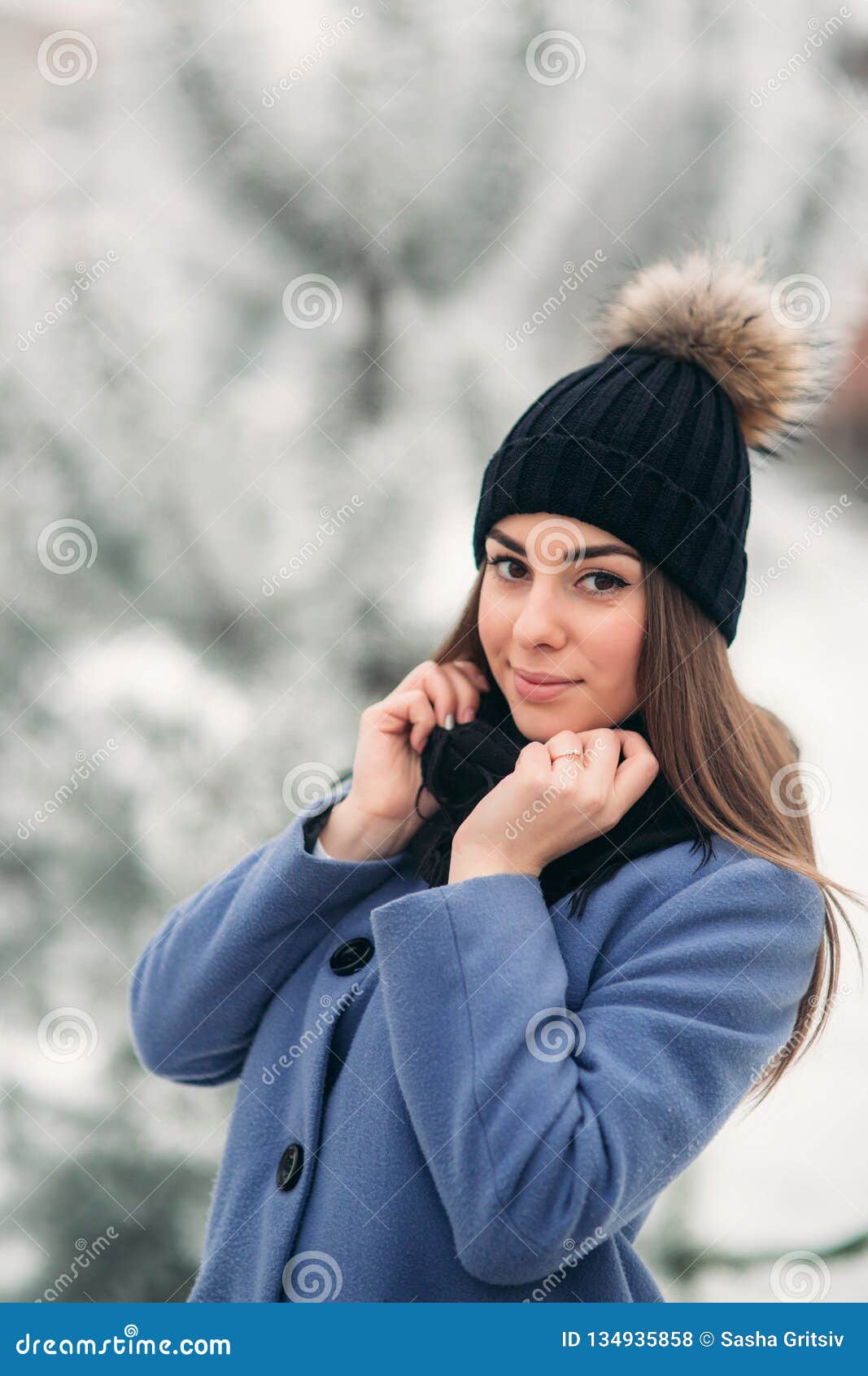 Portrait of Happy Young Woman Wearing Winter Hat and Scarf Stands Next ... Portrait of Happy Young Woman Wearing Winter Hat and Scarf Stands Next ...