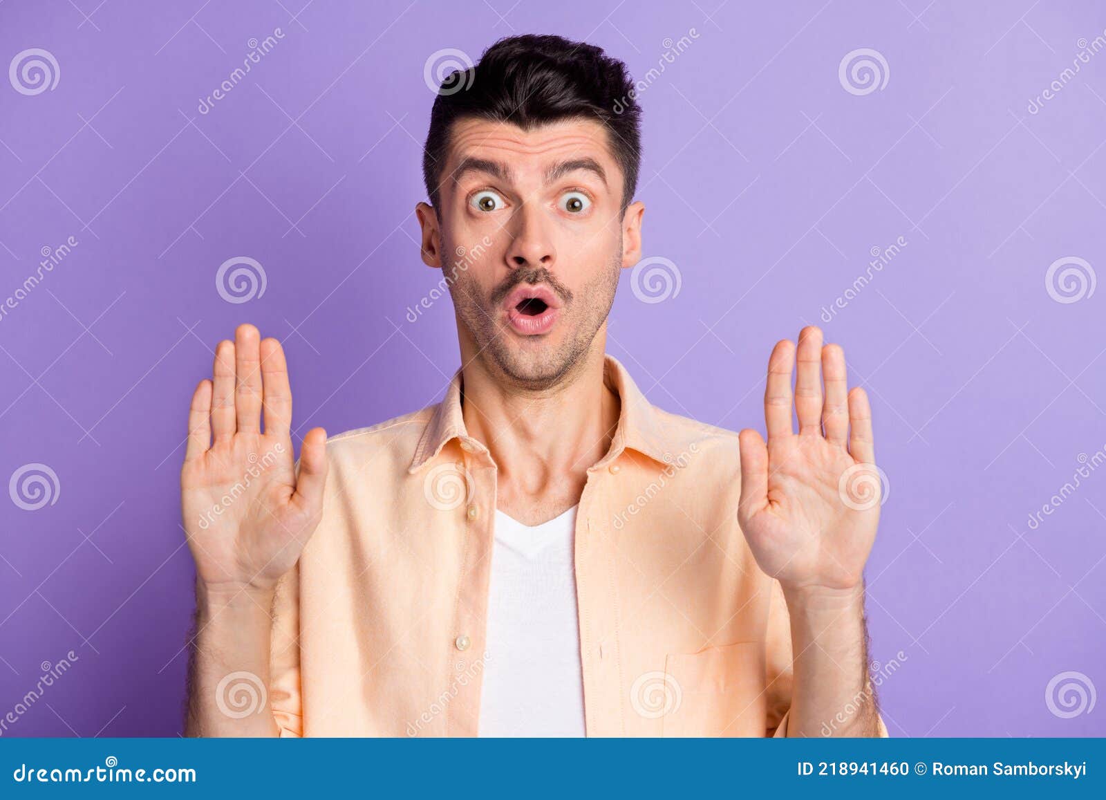 Portrait Of Impressed Brunet Guy Hands Up Stop Wear Peach Shirt