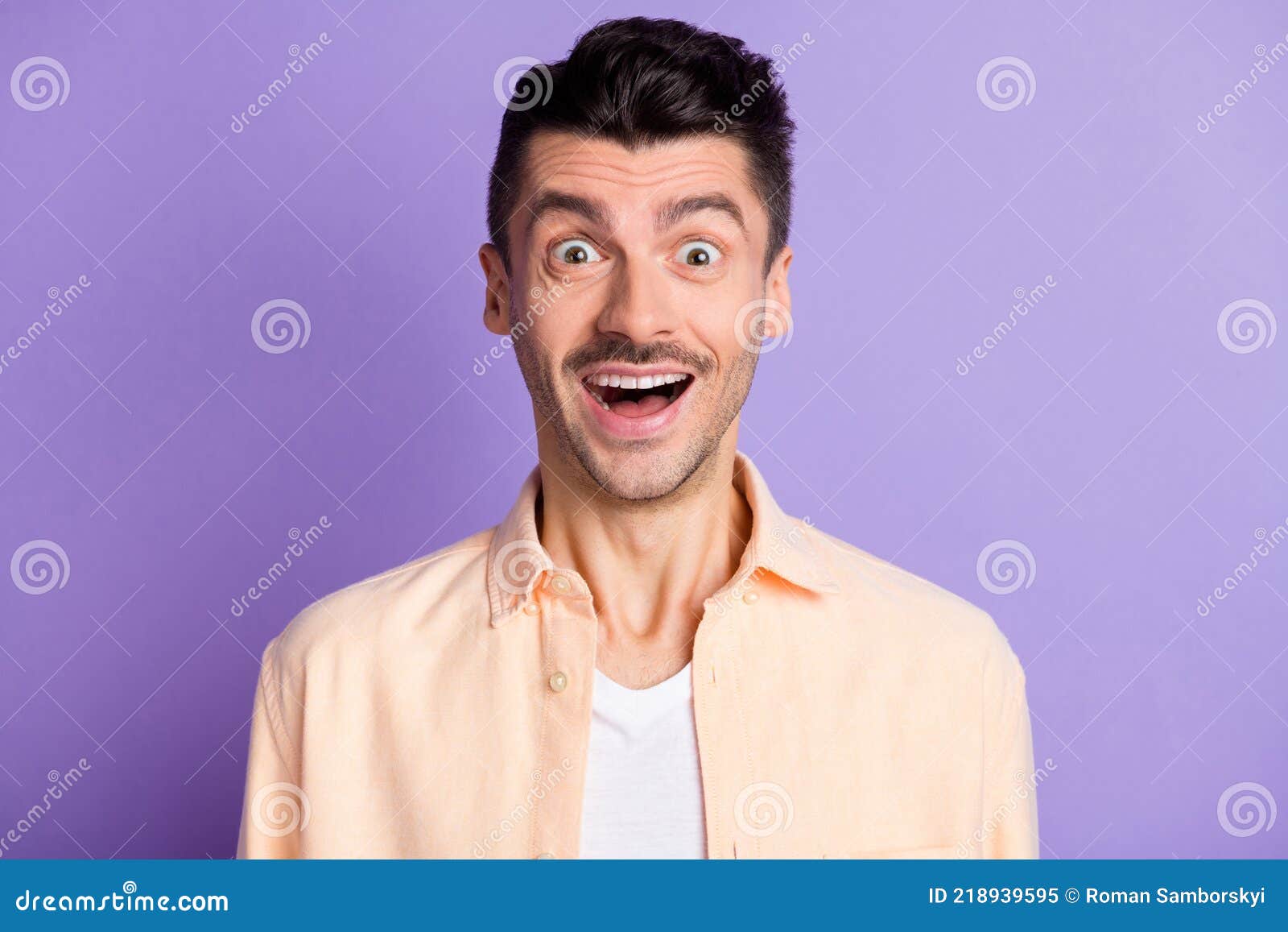 Portrait Of Impressed Funny Brunet Hair Guy Wear Peach Shirt Isolated