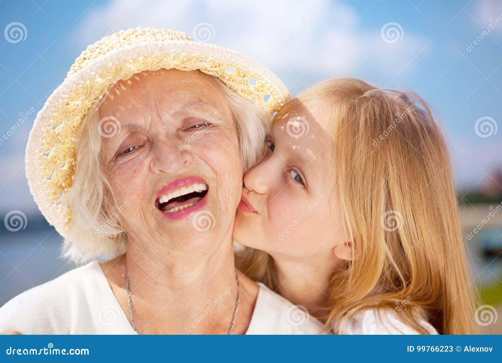 Portrait Of Kissing Grandmother And Granddaughter Looking At The Stock