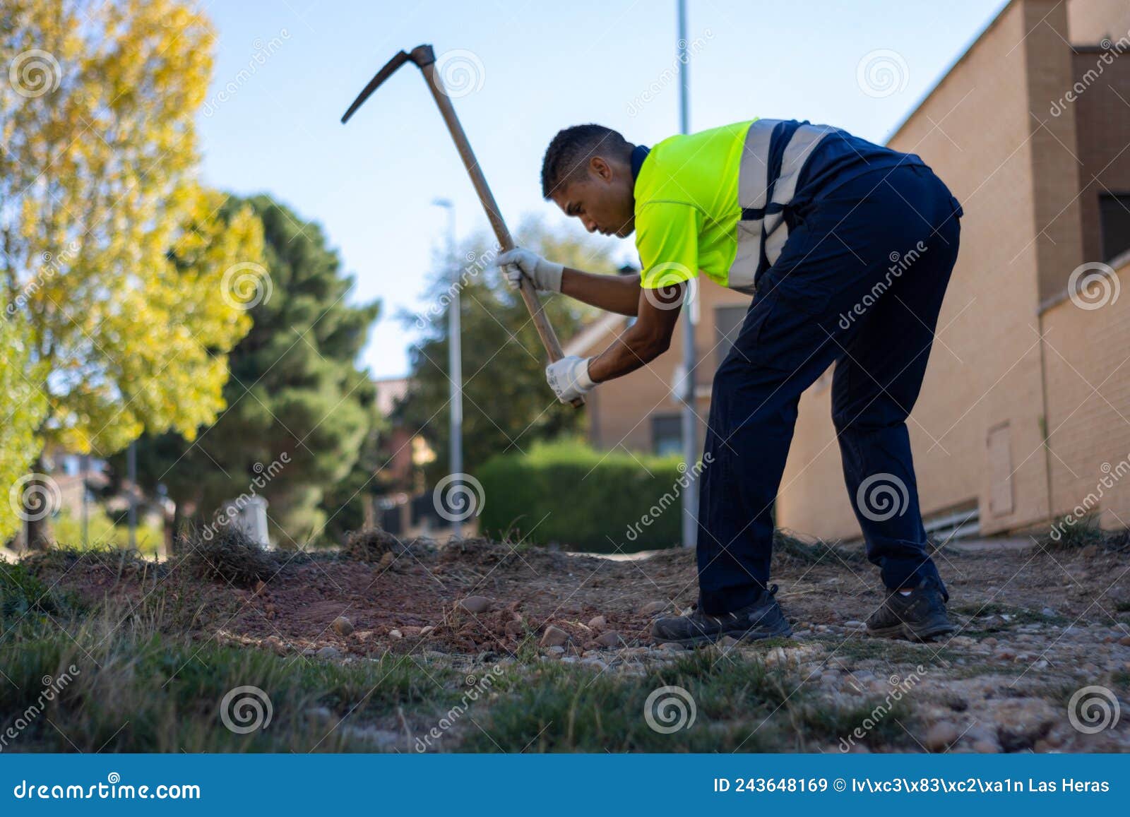 Portrait of Latin Worker Dressed in Work Clothes Digging the Earth with ...