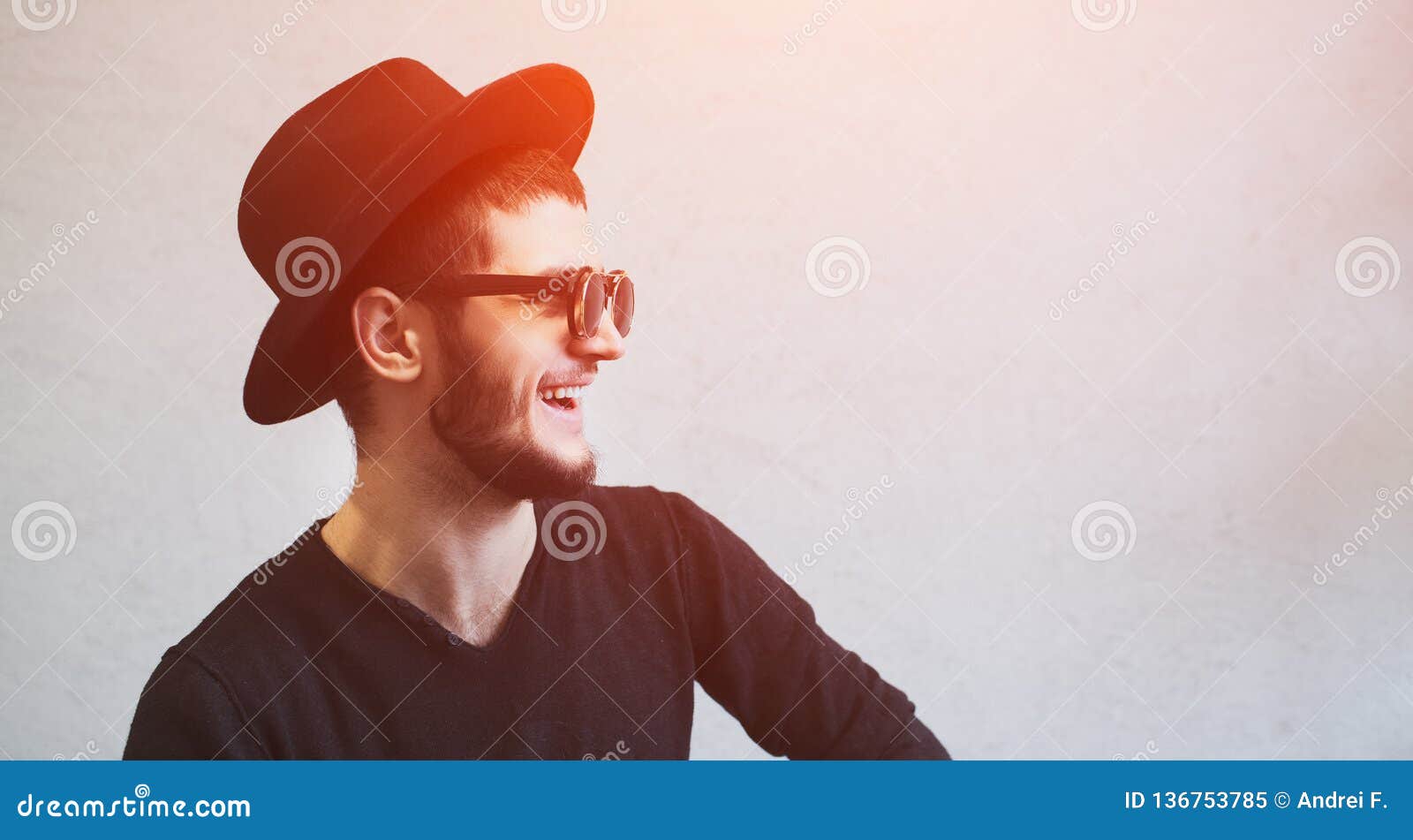 Portrait Of Laughing Bearded Man Wearing Sunglasses And Black Hat Stock