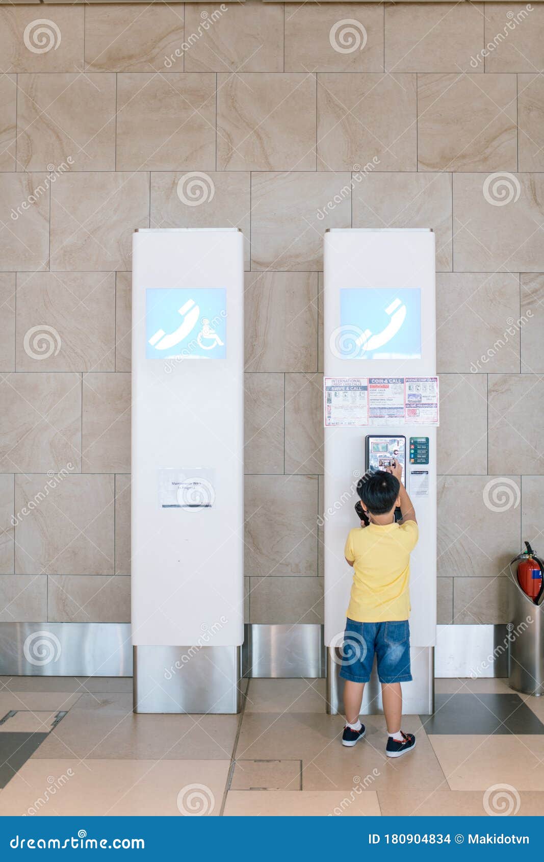 Portrait of a Little Boy Using a Payphone in an Airport Stock Photo ...
