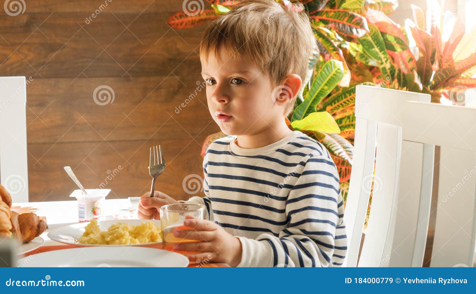 Portrait of Little 3 Years Old Boy Sitting Behind Dining Table while ...
