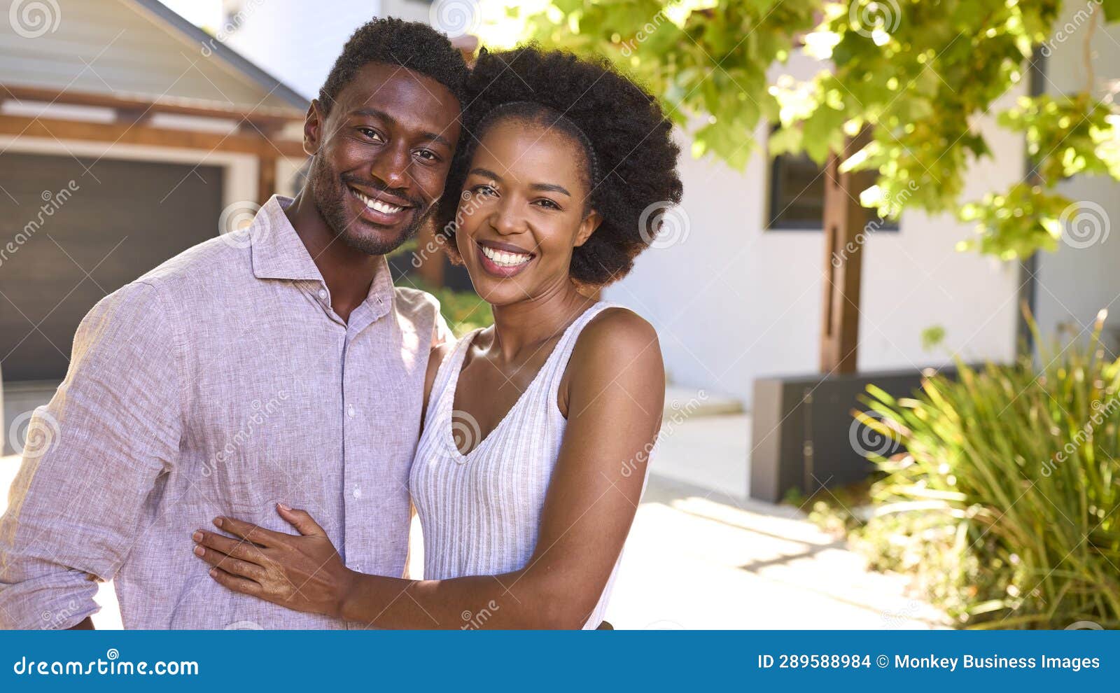 Portrait of Loving Couple Outdoors Hugging in Front of Home Stock Photo ...