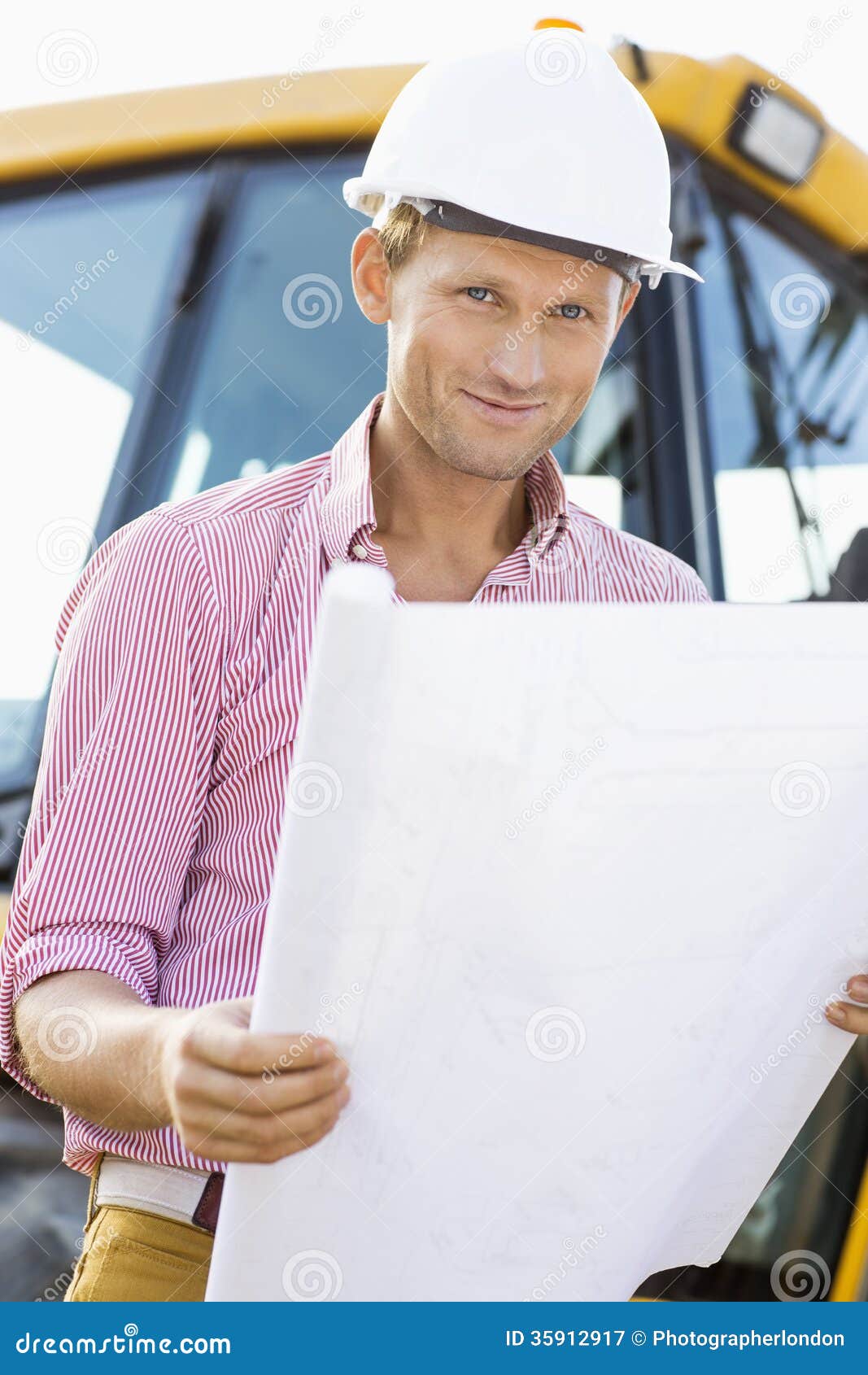 Portrait Of Male Architect Holding Blueprint At Construction Site Stock ... Portrait Of Male Architect Holding Blueprint At Construction Site Stock ...