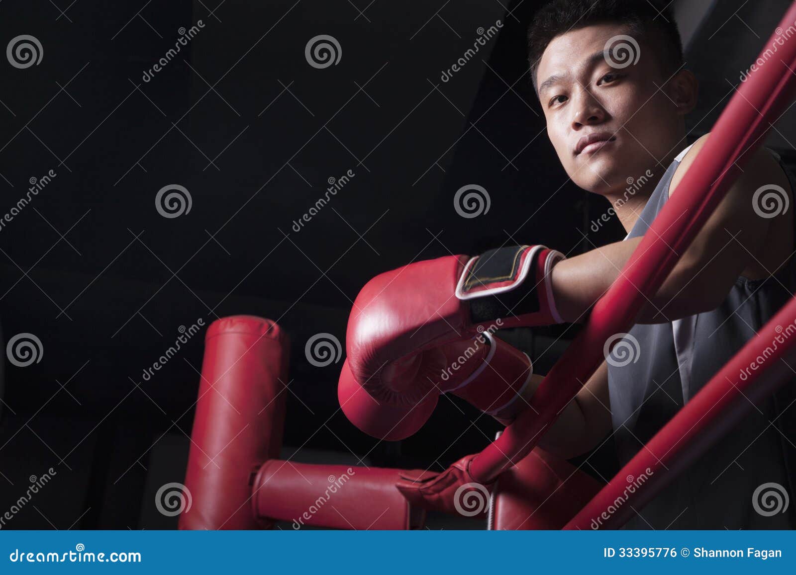 Portrait of Male Boxer Resting His Elbows on the Ring Side, Looking at ...
