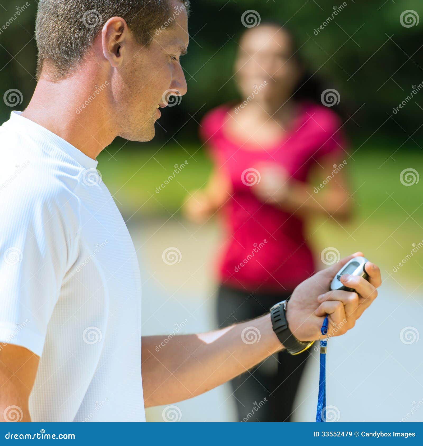 Portrait of Male Coach Timing Runner Stock Image - Image of female ...