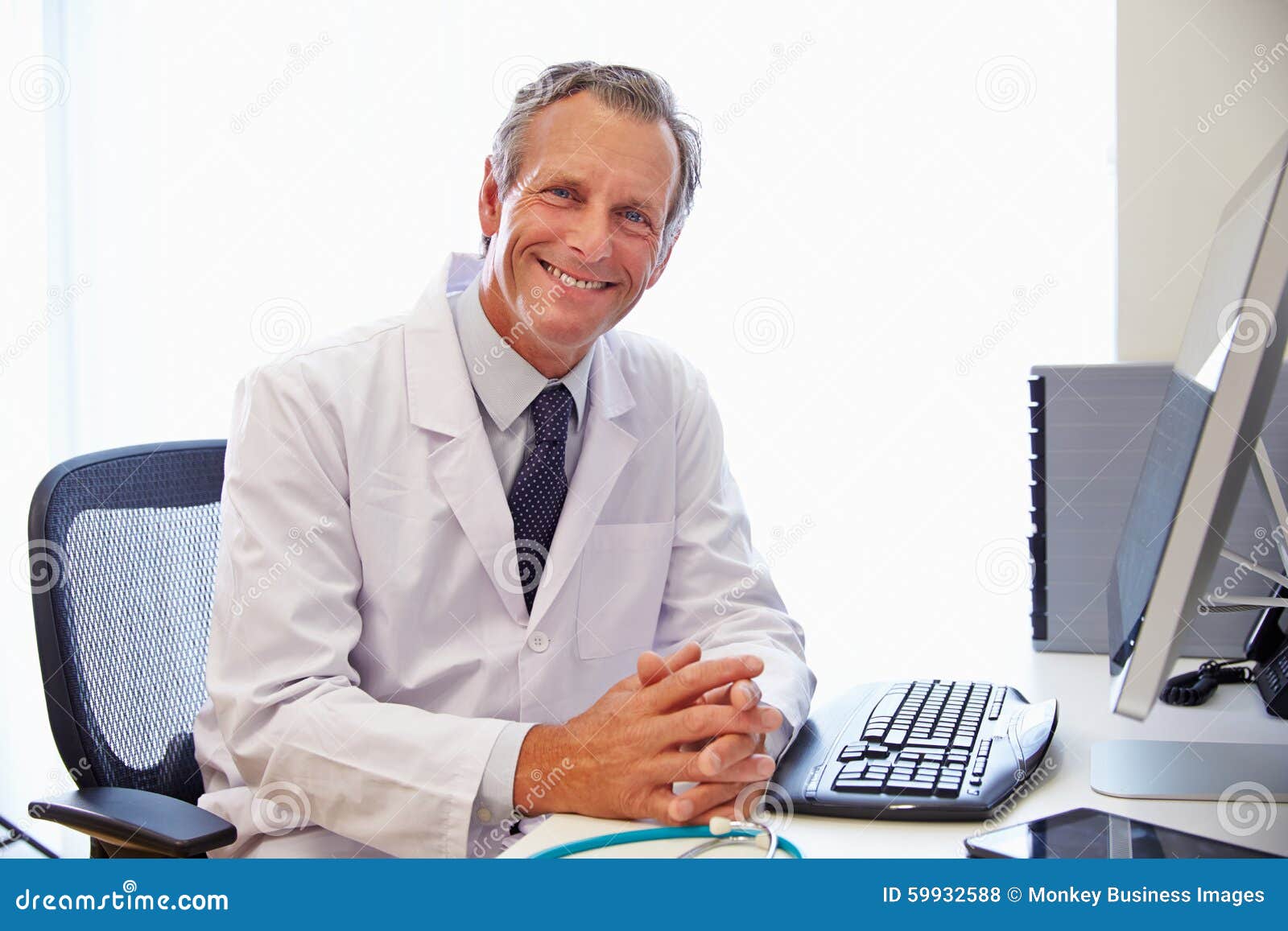 Portrait of Male Doctor in Office Working at Computer Stock Photo ...