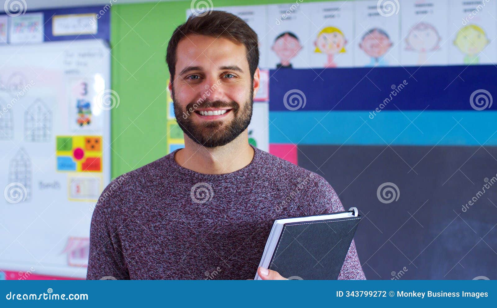Portrait of Male Elementary School Teacher Standing in Classroom ...