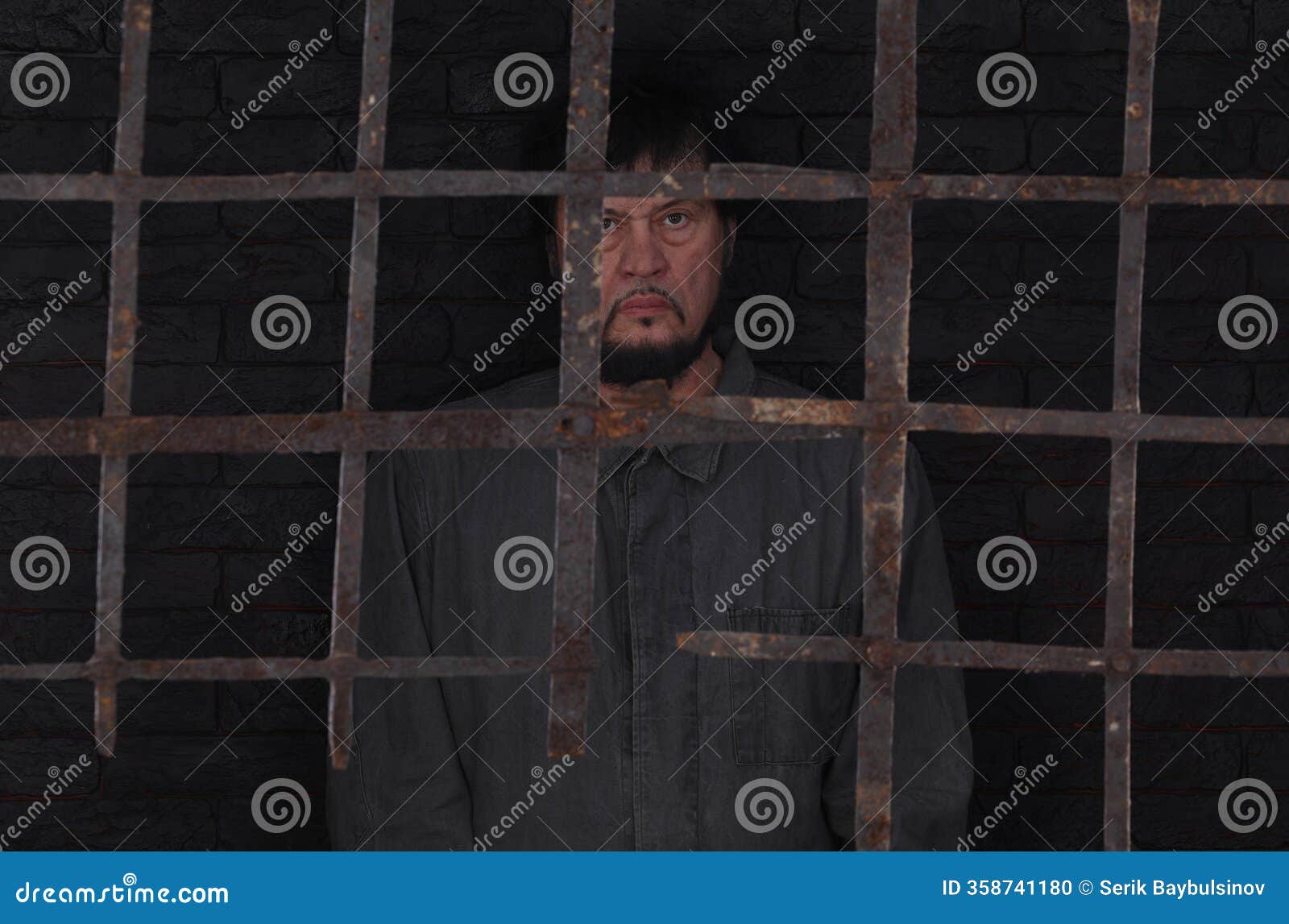 Portrait of a Male Prisoner Behind Bars in Prison Cell Stock Photo ...