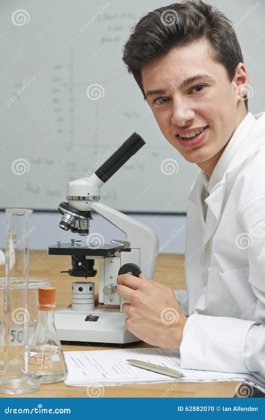 Portrait of Male Pupil Using Microscope in Science Laboratory Stock ...