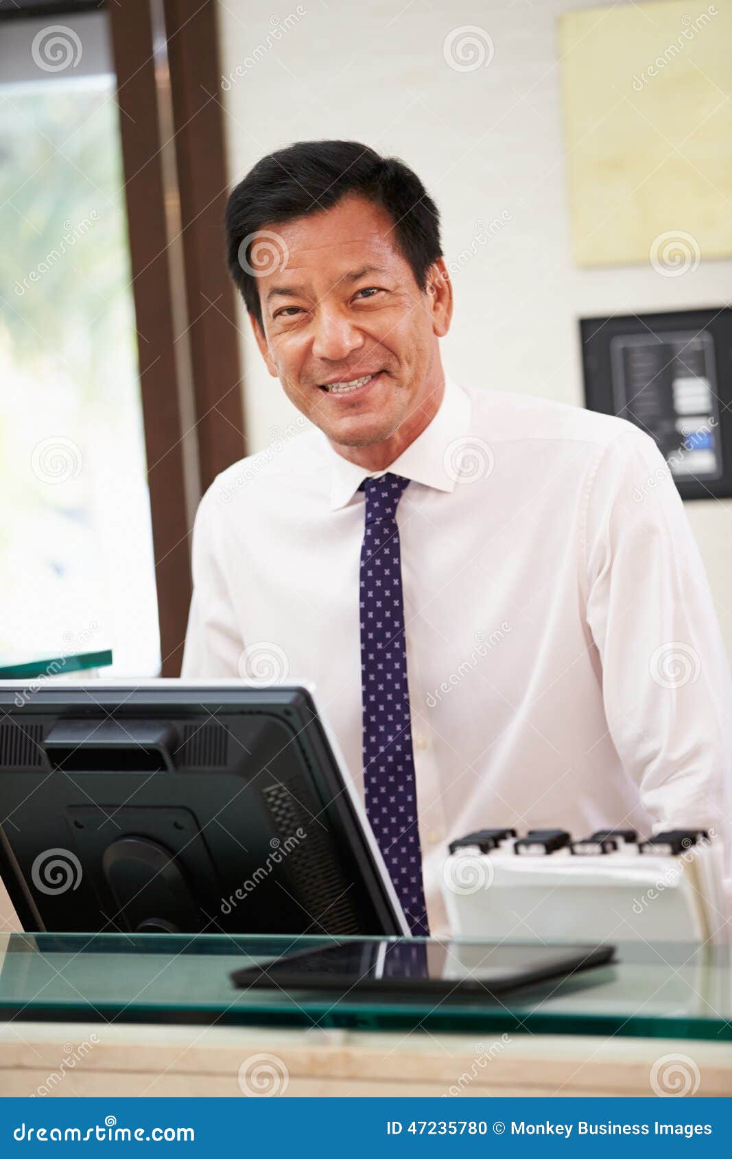 Portrait of Male Receptionist at Hotel Front Desk Stock Photo - Image ...