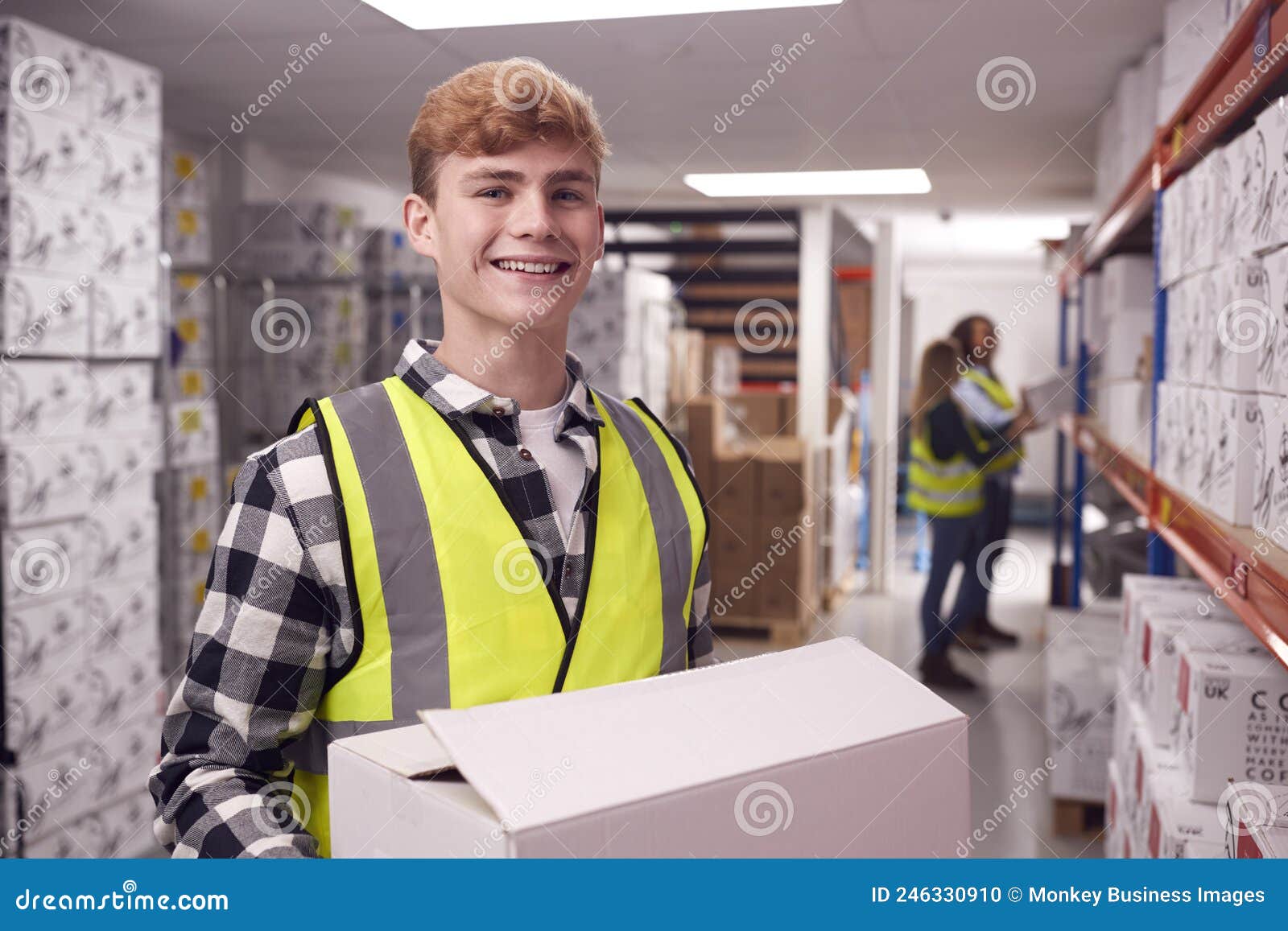 Portrait of Male Worker Inside Busy Warehouse Carrying Box Stock Photo ...