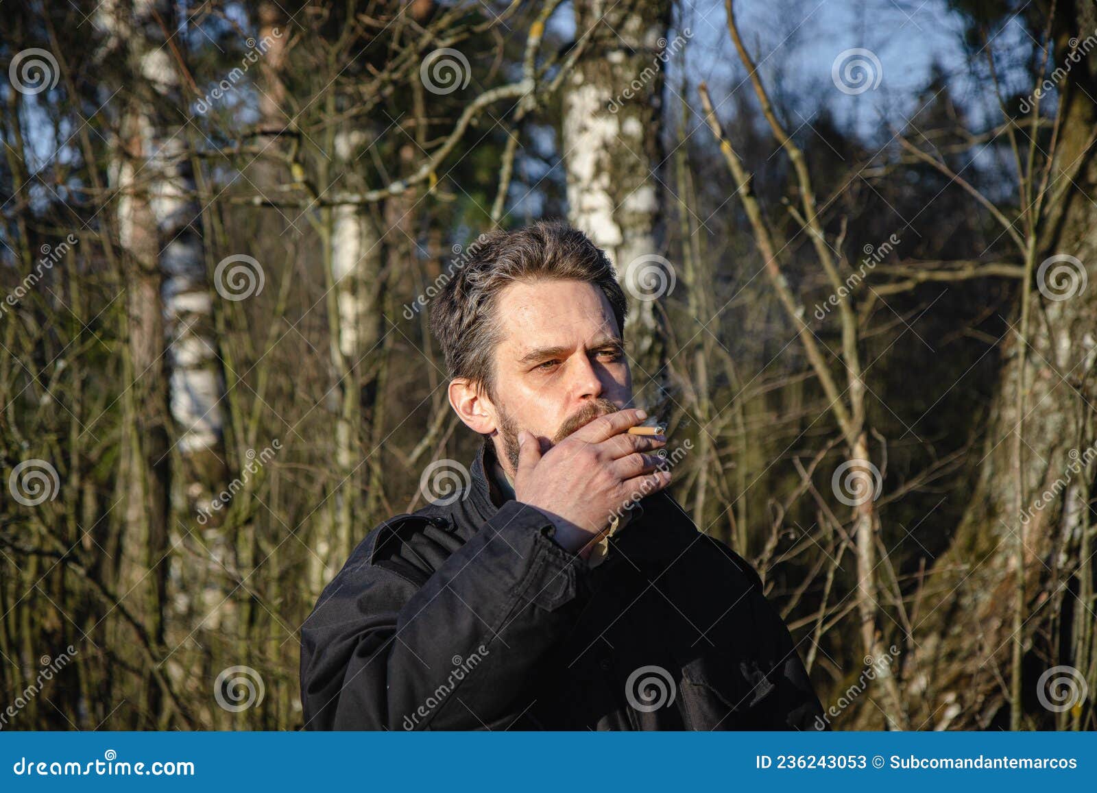 Portrait of a Man with a Beard and a Cigar in the Spring Forest Stock ...