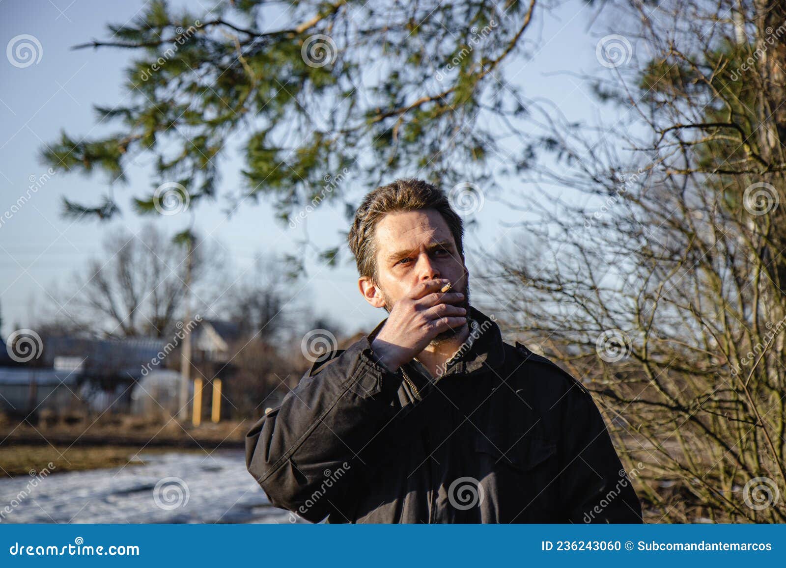 Portrait of a Man with a Beard and a Cigar in the Spring Forest Stock ...