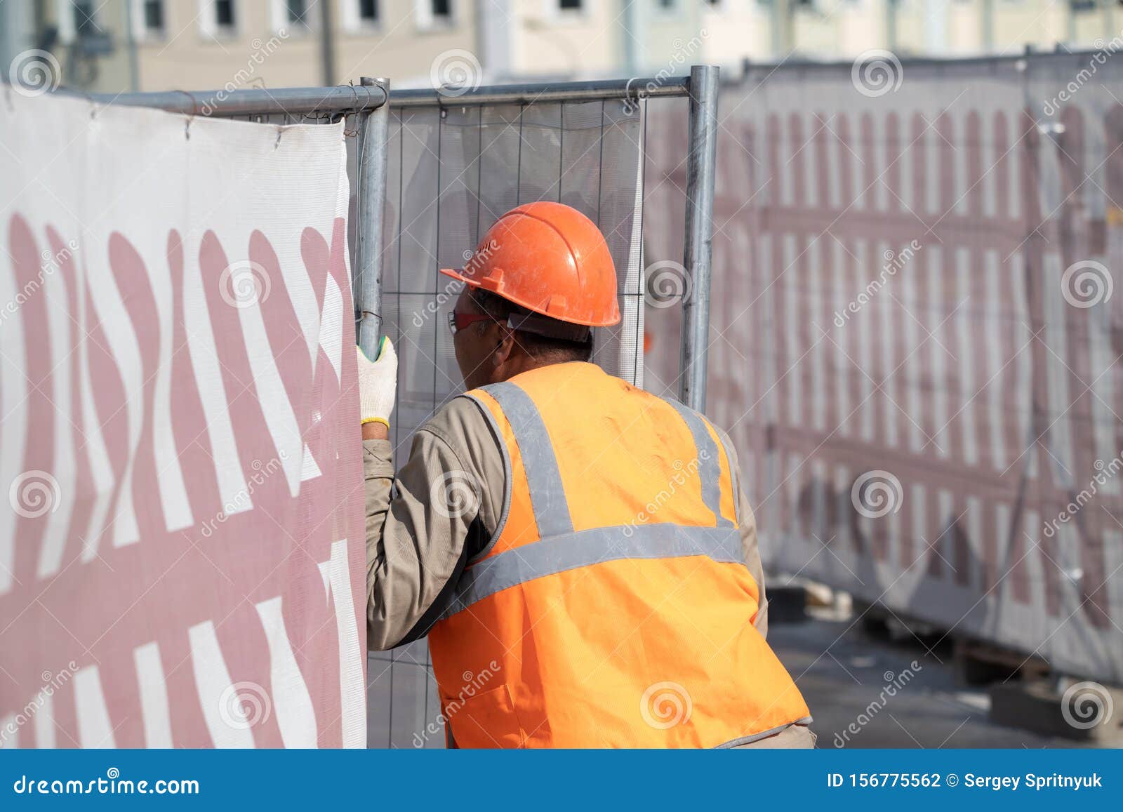 Portrait Of A Man From Behind In A Construction, Orange Helmet Against ...