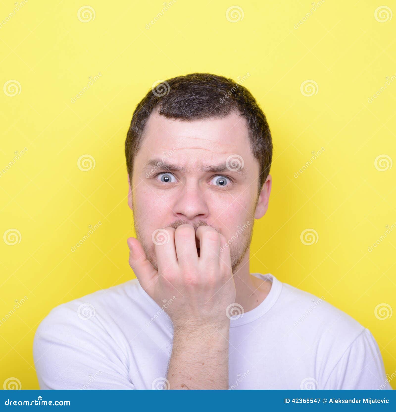 Portrait of Man Biting Nails Against Yellow Background Stock Image ...