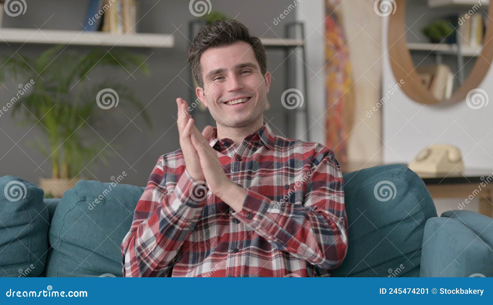 Portrait of Man Clapping while Sitting on Sofa Stock Image - Image of ...