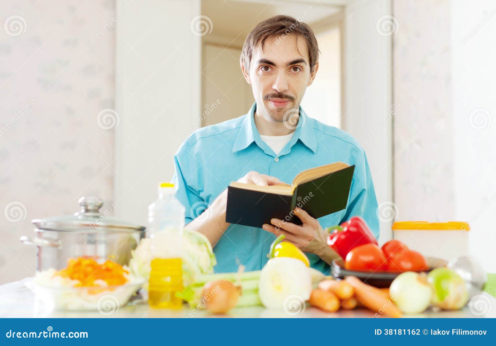 Portrait of Man with Cookbook in Domestic Kitchen Stock Photo - Image ...