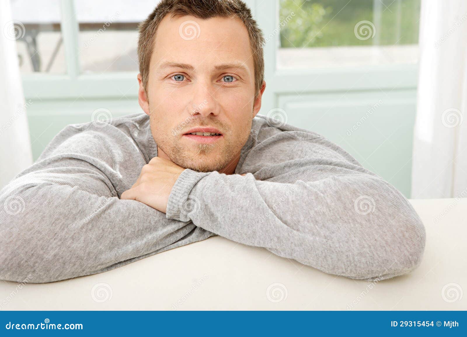 Portrait of man by couch. stock photo. Image of buildings - 29315454