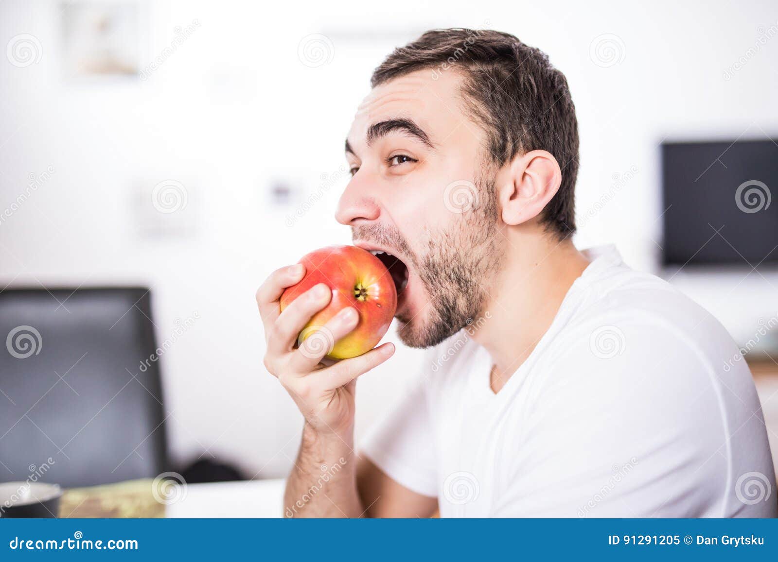 Portrait of a Man Eating an Apple in the Kitchen Stock Image - Image of ...
