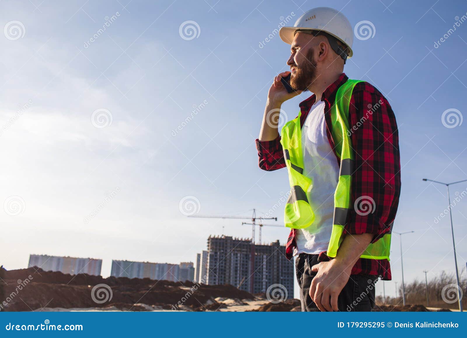 A Portrait of Man Engineer with Smartphone in a Construction Site ...