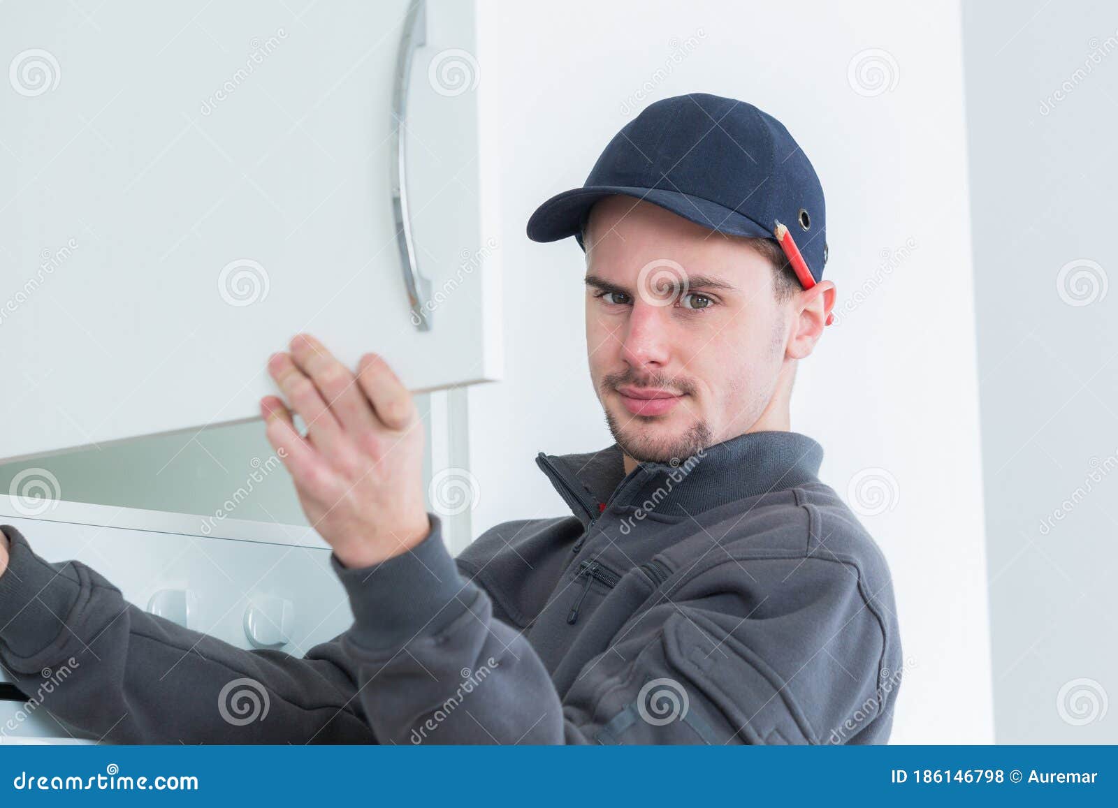 Portrait Man Fitting Kitchen Cupboard Stock Photo - Image of white ...