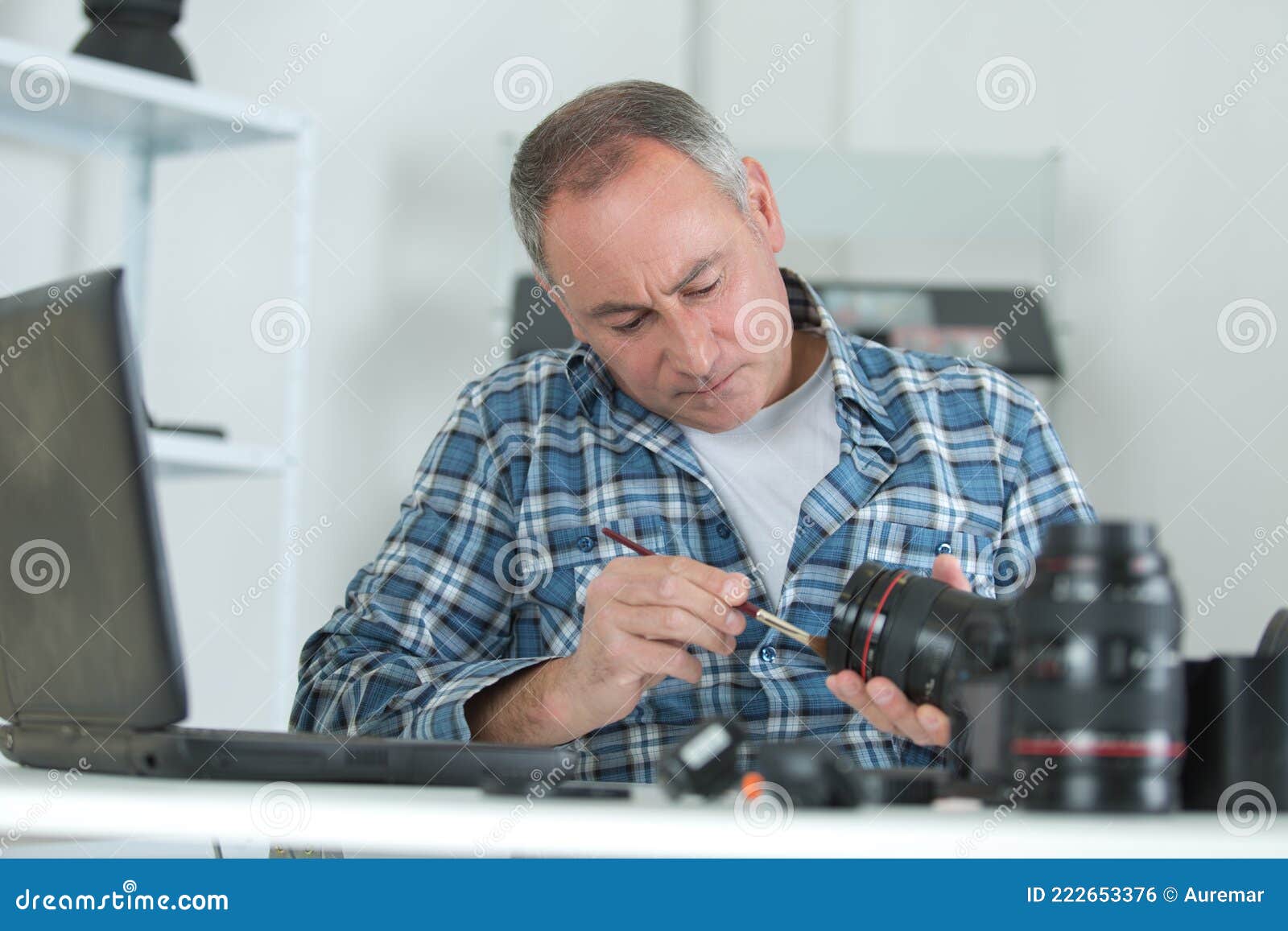Portrait man fixing camera stock photo. Image of view - 222653376