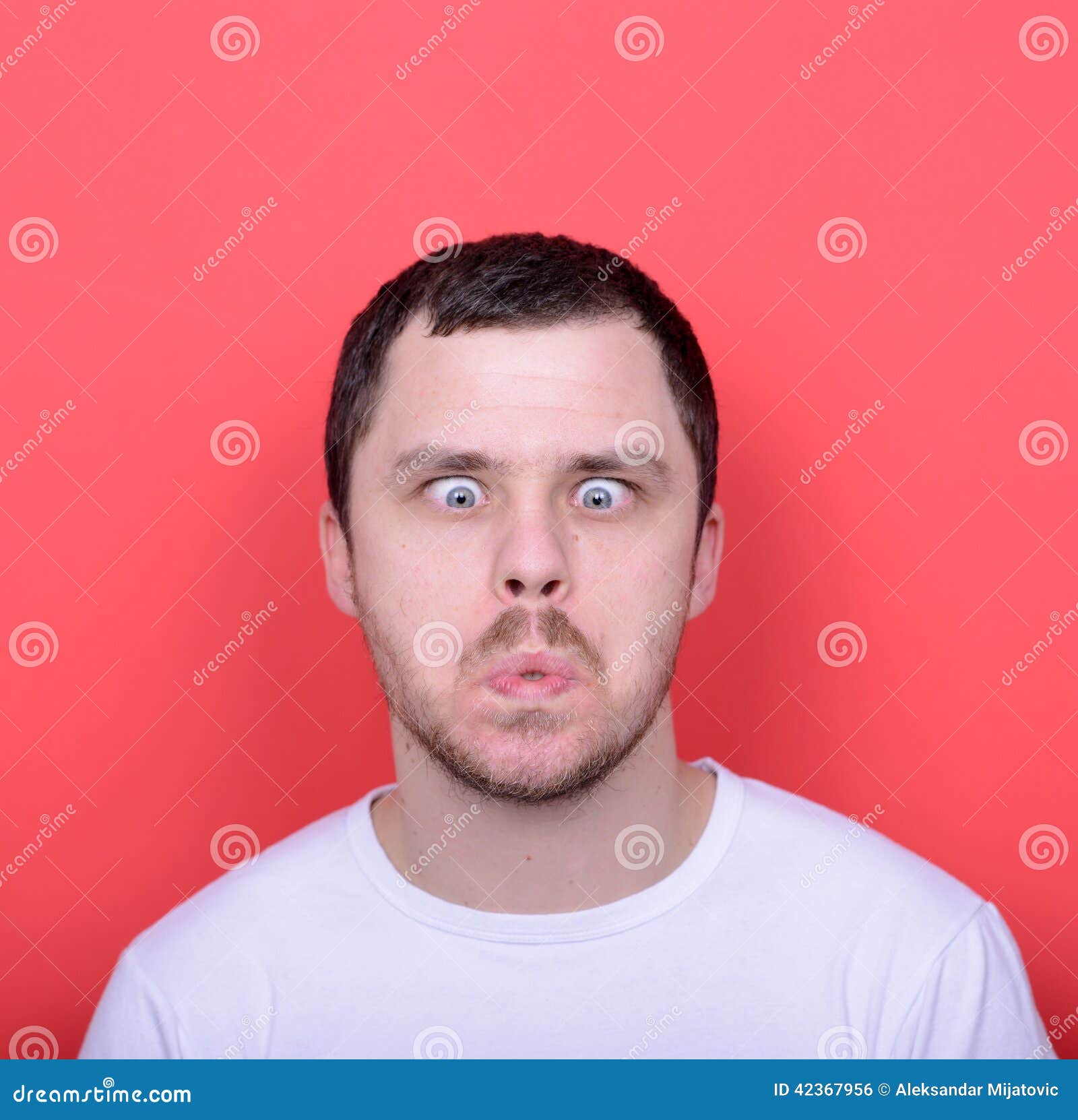 Portrait of Man with Funny Face Against Red Background Stock Photo ...