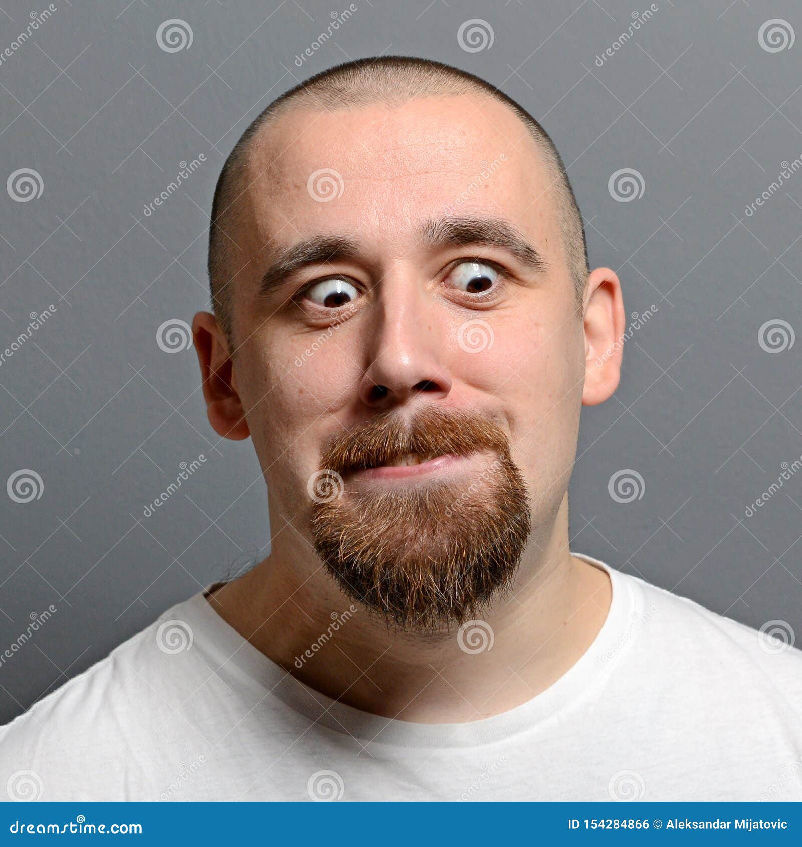 Portrait of a Man Making Funny Face Against Gray Background Stock Photo ...