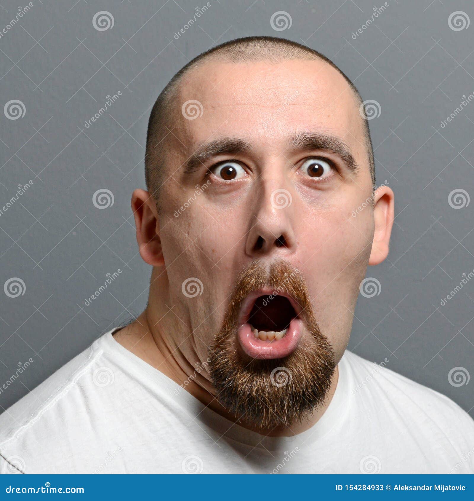 Portrait of a Man Making Funny Face Against Gray Background Stock Image ...