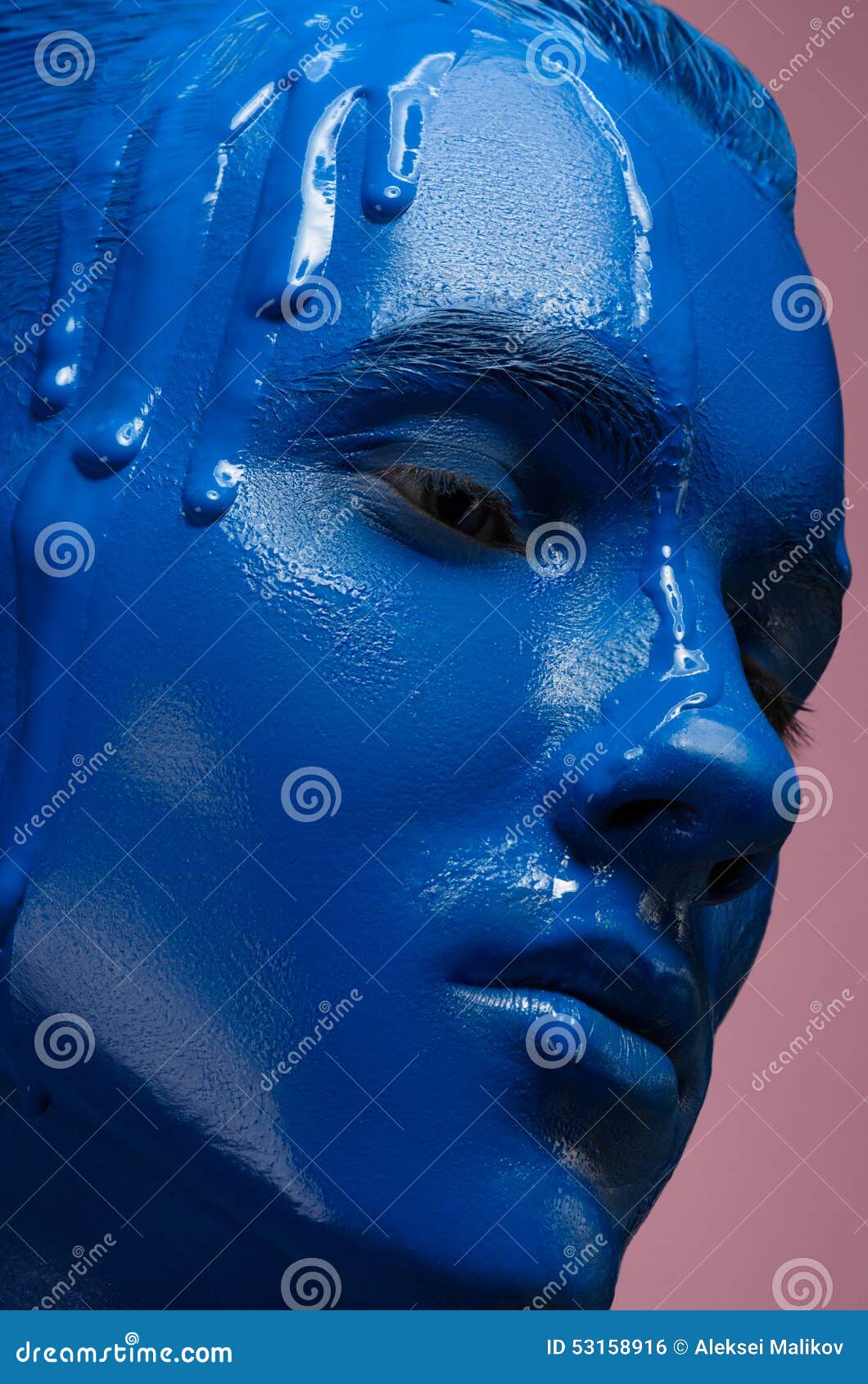 Portrait of a Man Poured Blue Paint on a Pink Background Stock Photo ...