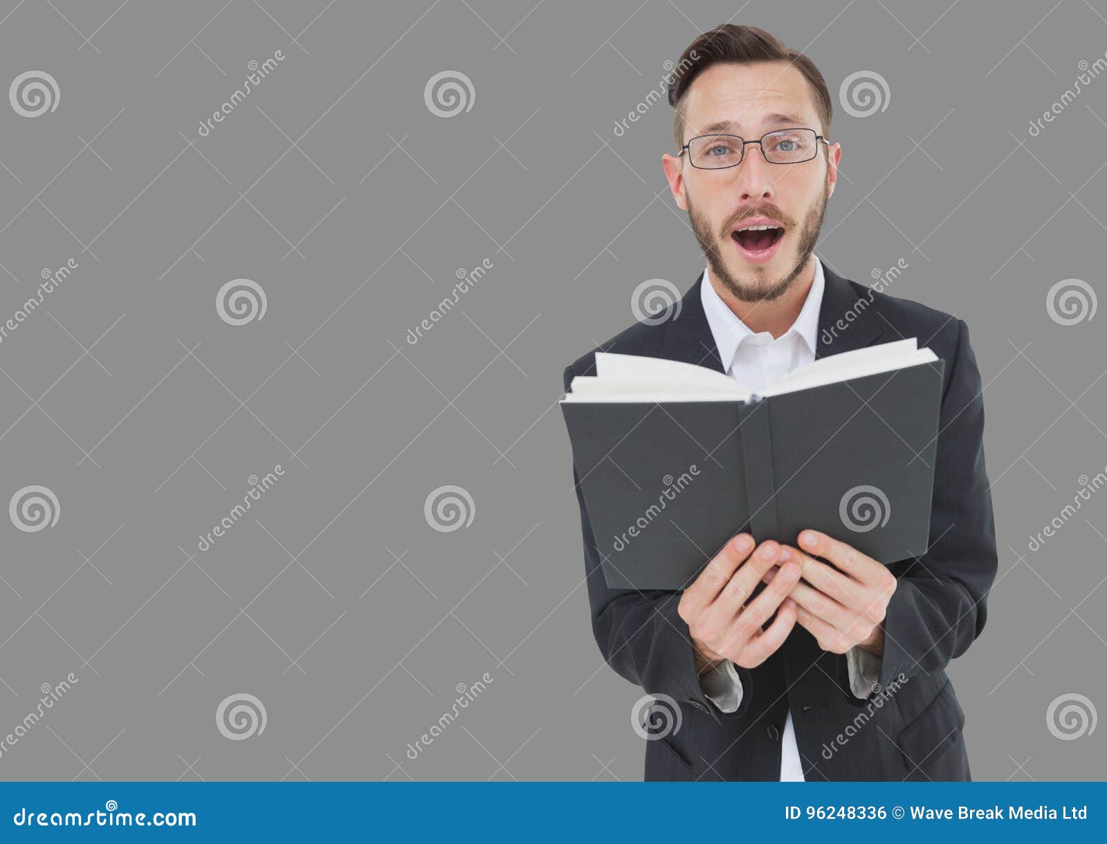 Portrait of Man Reading Book Out Loud with Grey Background Stock Photo ...