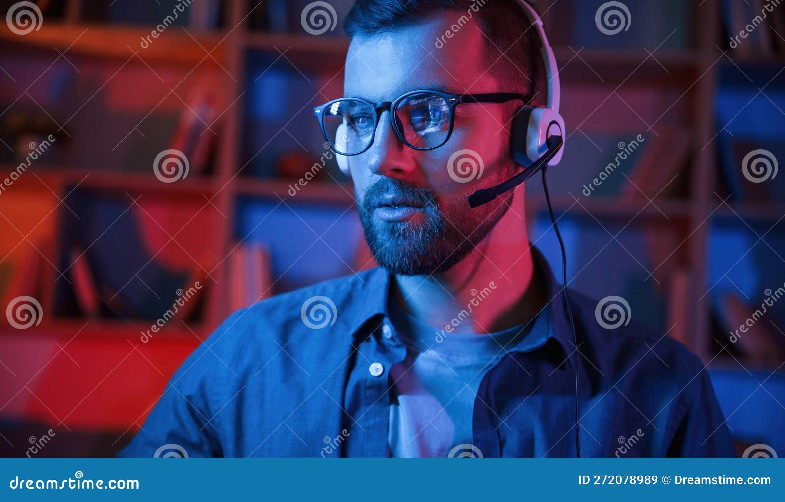Portrait of Man that is Sitting by a Computer Indoors at Home. Neon ...