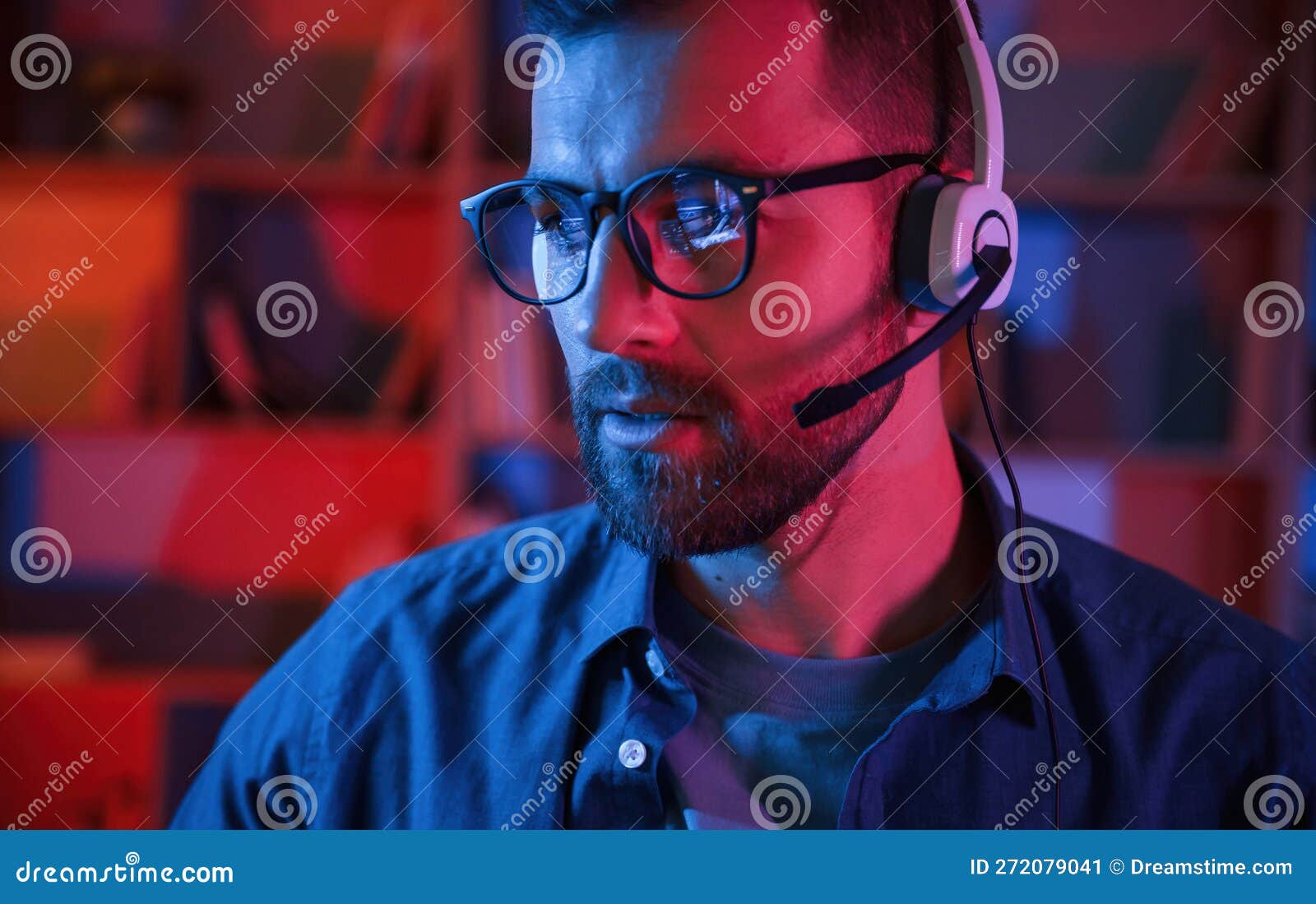 Portrait of Man that is Sitting by a Computer Indoors at Home. Neon ...