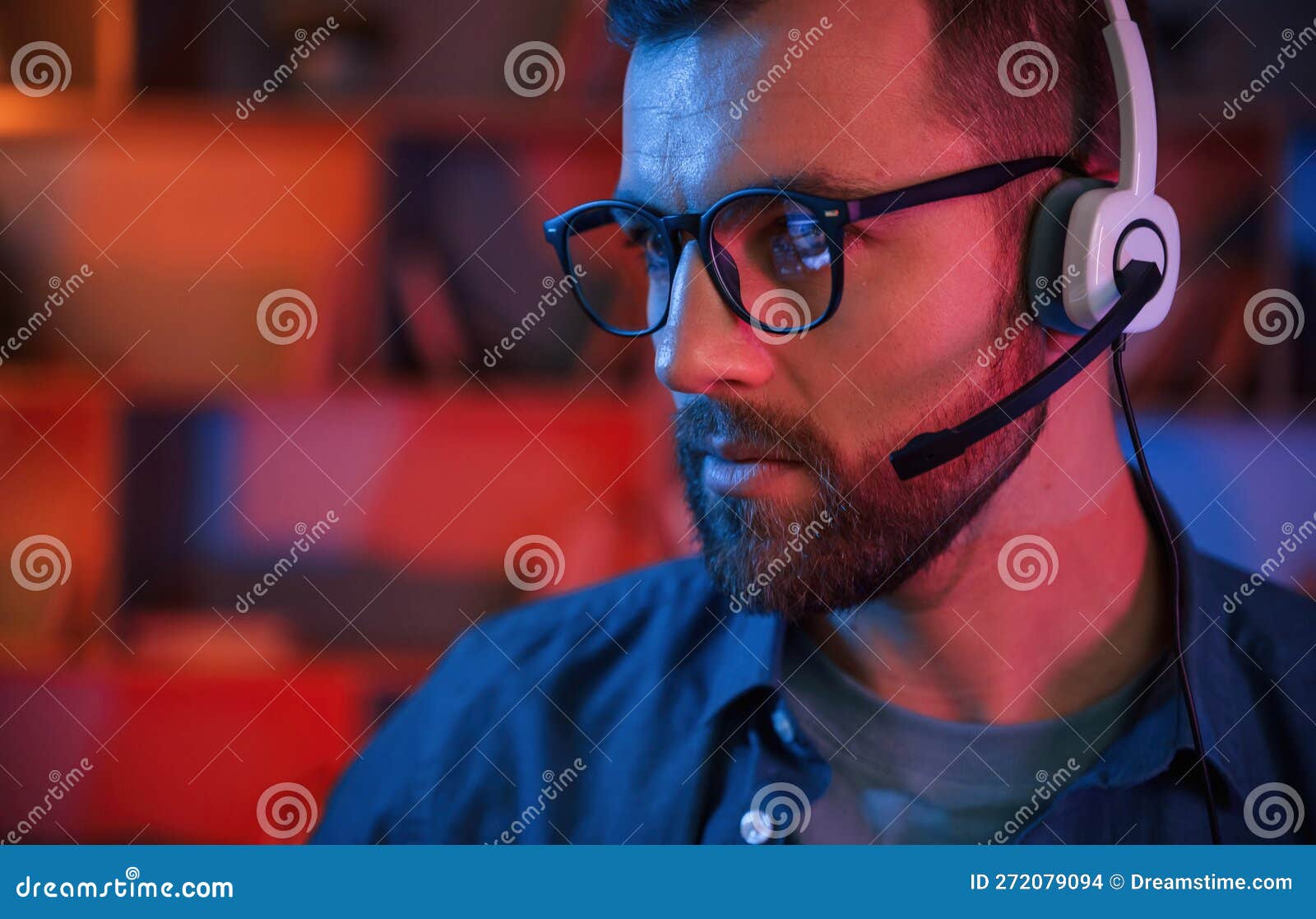 Portrait of Man that is Sitting by a Computer Indoors at Home. Neon ...