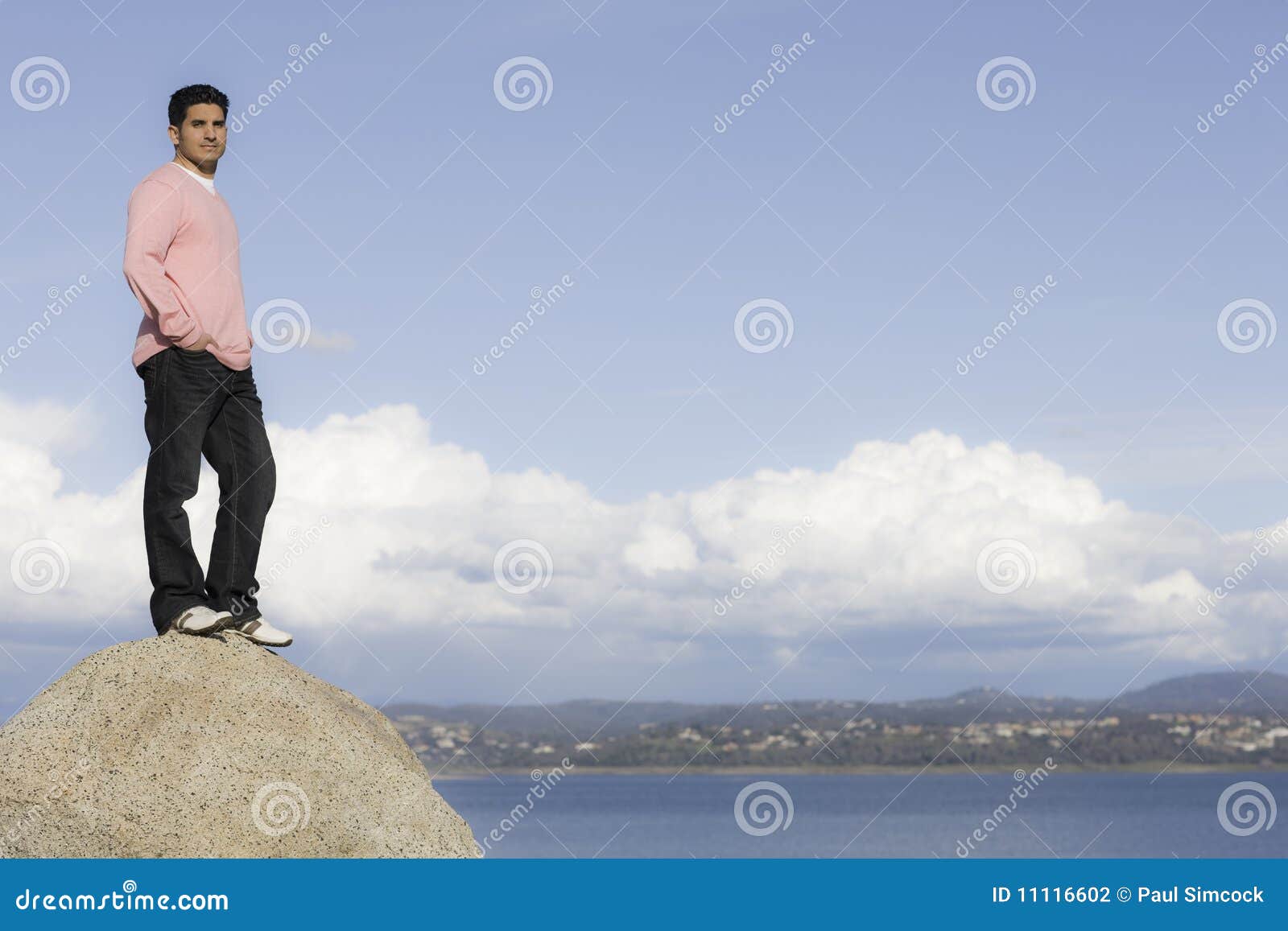 Portrait of Man Standing on Rock Stock Photo - Image of blue, serene ...