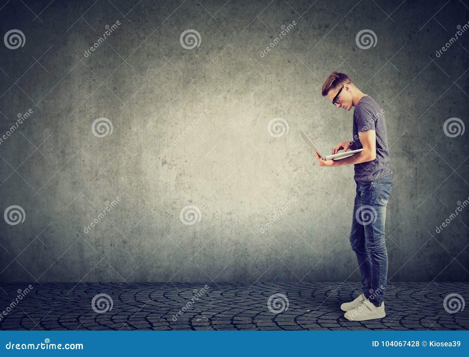 Portrait of a Man Standing Using His Laptop Computer Stock Photo ...
