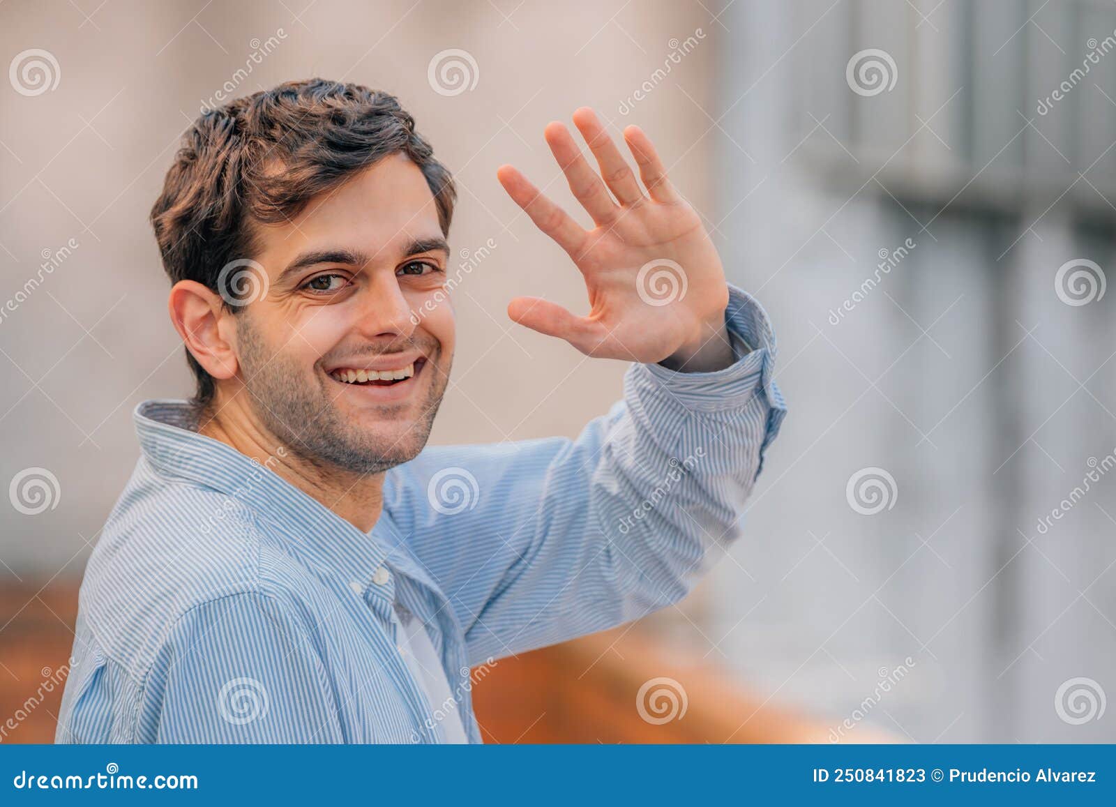 Man in the street waving stock image. Image of gesture - 250841823