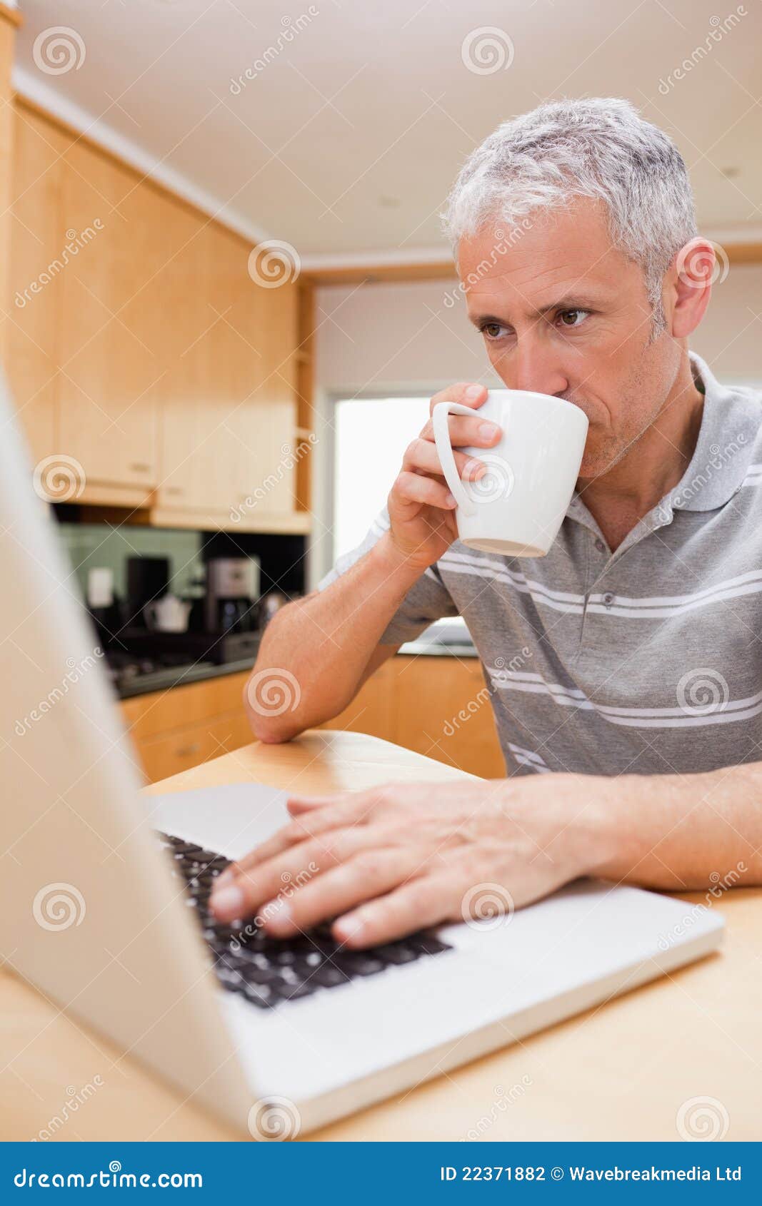 Portrait of a Man Using a Laptop while Drinking Coffee Stock Photo ...